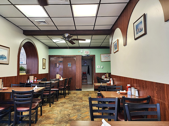 Wood paneling meets mint green walls in this cozy dining room where conversations flow as freely as the coffee. Classic diner charm at its finest.