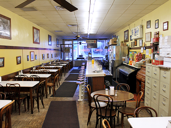 Step inside and you're transported to a bygone era where yellow walls, vintage photos, and no-nonsense seating tell you to focus on what matters: the food.