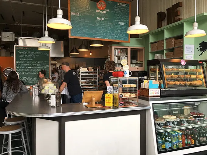 Pie headquarters in full swing! The bustling counter, chalkboard menu, and display cases showcase the serious business of making people happy through pastry.