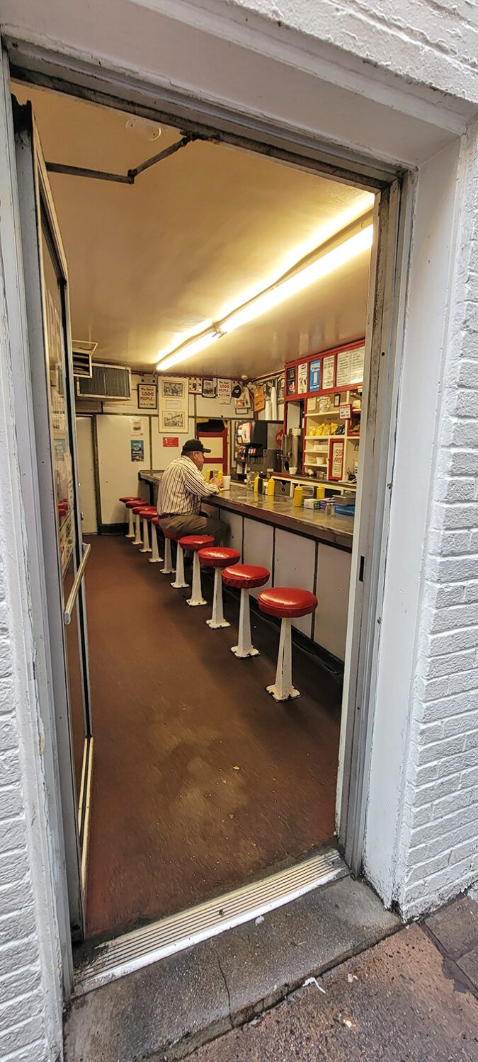 Step inside and you're transported to a simpler time—ten red stools, a narrow counter, and the promise of comfort food that hasn't changed in decades.