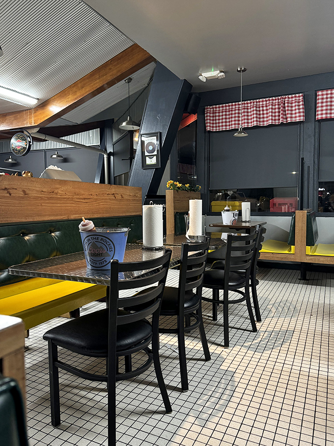 Classic checkered curtains and comfortable booths create that "you've arrived" feeling. The paper towel rolls aren't decorative—they're a promise of deliciously messy things to come.