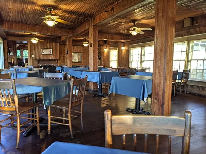 Where wood-paneled nostalgia meets mouthwatering anticipation. Those blue tablecloths have witnessed countless "Oh my goodness" first bites.