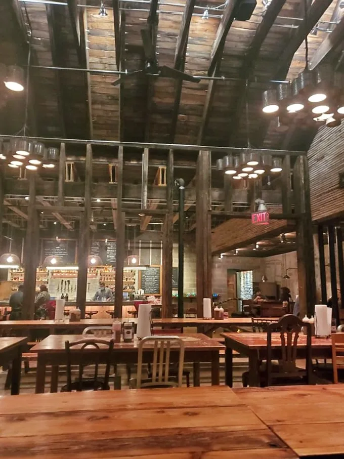 Cathedral of carnivores: soaring wooden beams frame communal tables where strangers become friends over shared plates of smoky perfection.