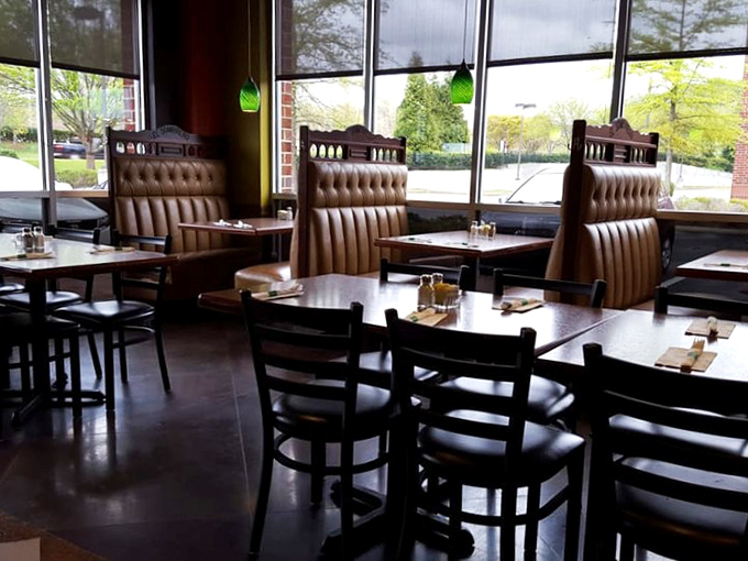 Comfortable leather booths and clean wooden tables create a welcoming atmosphere where conversations flow as easily as the margaritas. Those green pendant lights add just the right touch.
