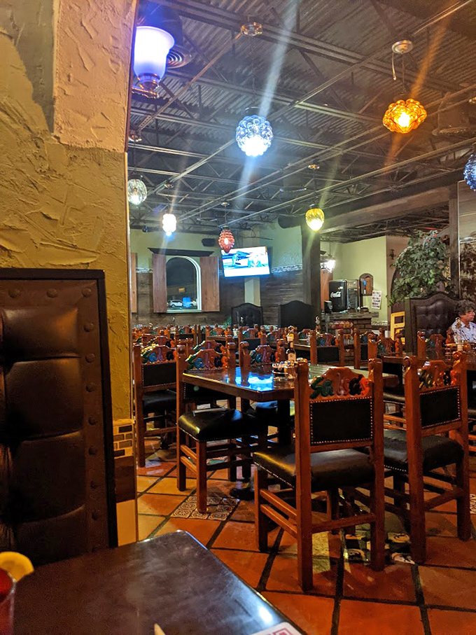 Colorful pendant lights cast a festive glow over handcrafted wooden furniture. This isn't designer ambiance—it's something far better: authenticity.