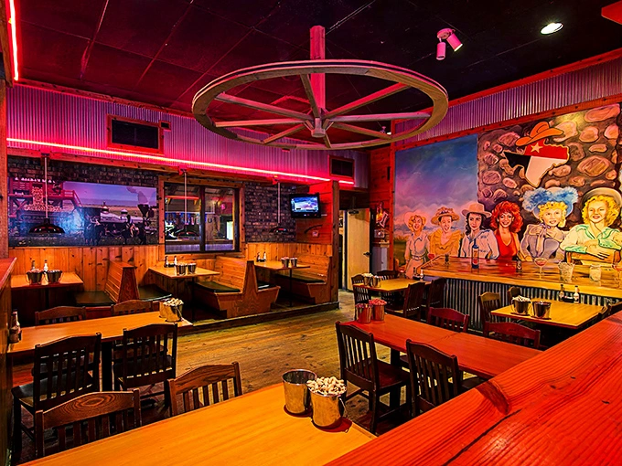 Wagon wheels overhead, neon glow, and cowboy murals—this isn't just dinner, it's a mini-vacation to the Lone Star State.
