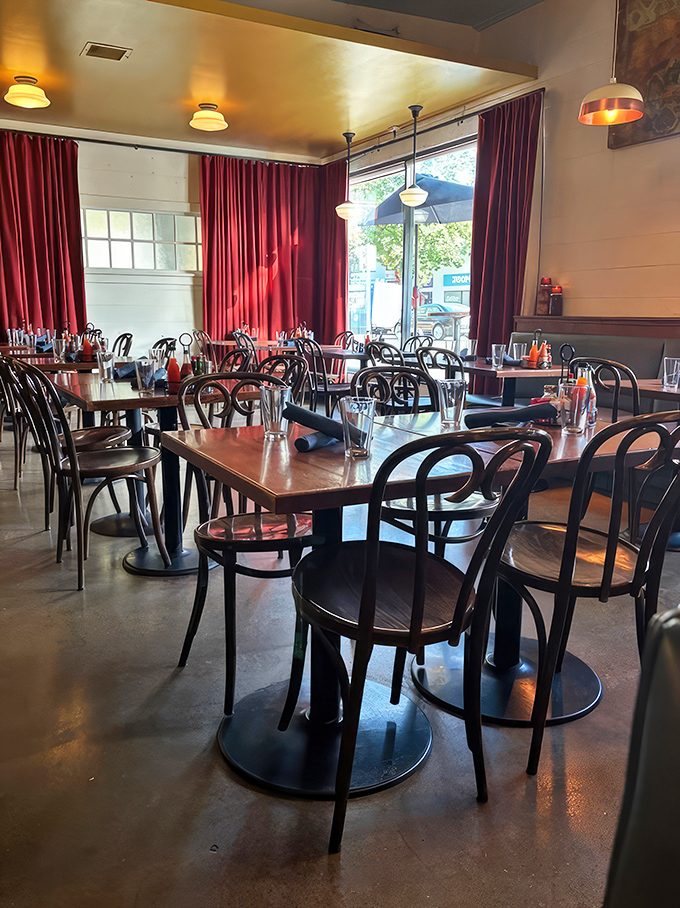 Red curtains and bentwood chairs create an atmosphere that's both homey and hip—like your coolest aunt's dining room.
