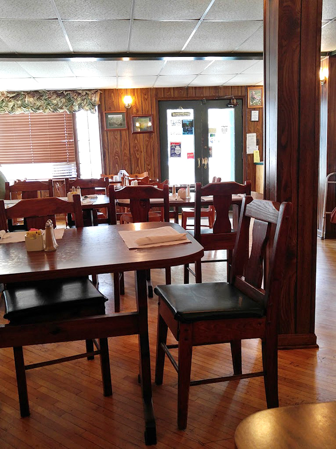 Wood-paneled walls and sturdy furniture create the perfect backdrop for comfort food magic. No designer needed – just decades of honest hospitality.