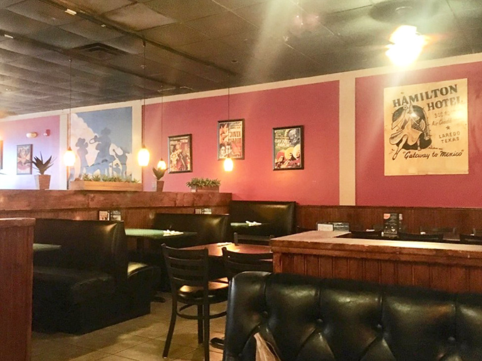 Pink walls adorned with vintage Mexican posters create a warm atmosphere that's both welcoming and authentic without trying too hard.