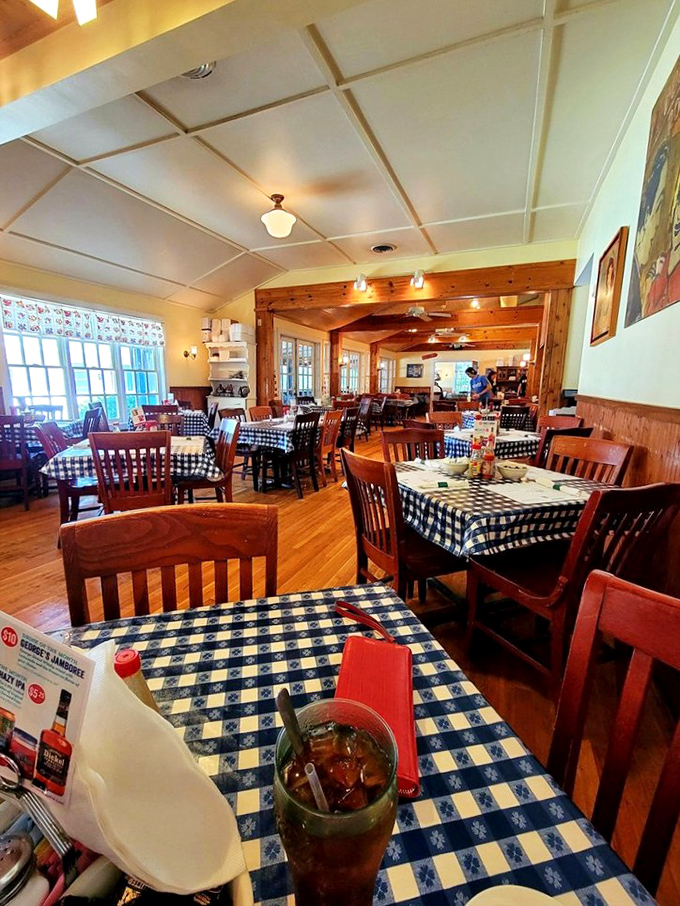 Blue-checkered tablecloths and warm wood beams create the perfect backdrop for comfort food conversations. This isn't décor—it's a Southern hug in restaurant form.