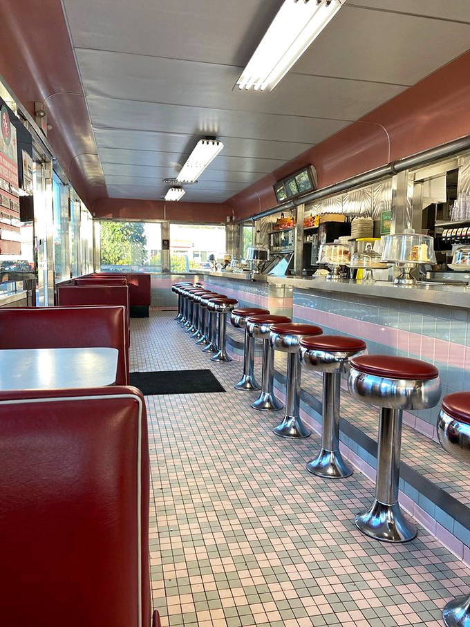 The classic counter with those fire-engine red vinyl booths isn't just seating—it's a time portal where calories don't count and conversations flow like coffee.