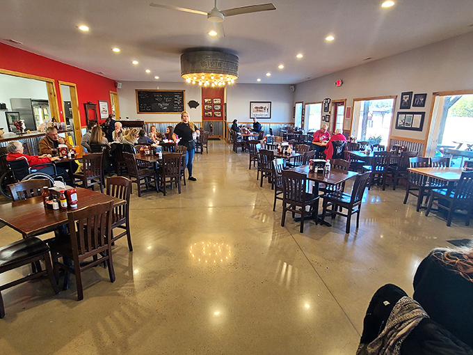 Inside, the spacious dining room balances rustic charm with practical comfort. That overhead drum light fixture? Pure North Carolina ingenuity.