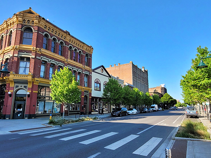 The dramatic two-world split of Port Townsend—Victorian mansions perched above brick storefronts below—creates a postcard-perfect maritime tableau.
