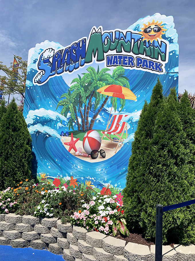 The cheerful Splash Mountain sign stands like a portal to childhood summers, complete with a sunglasses-wearing sun who clearly knows how to party.