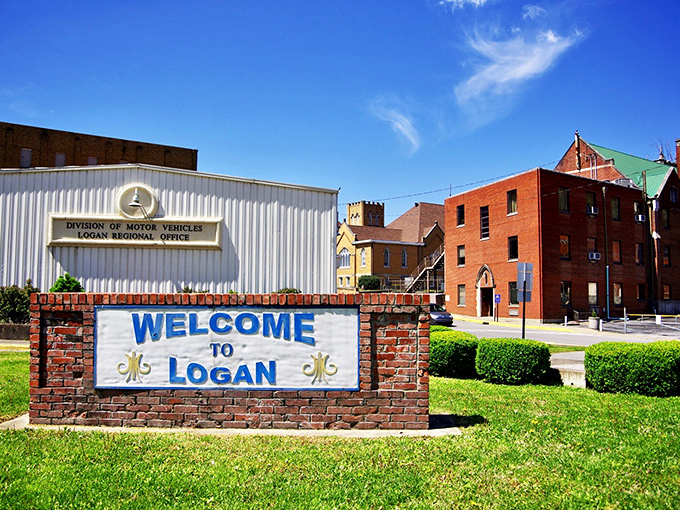 This welcome sign doesn't just mark a town boundary—it's the doorway to stories waiting to be discovered in Logan's brick-lined streets.