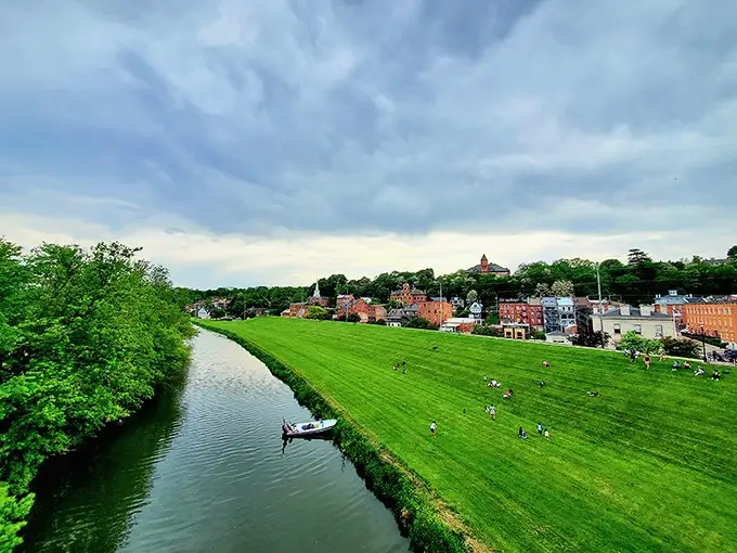 The emerald riverbank and historic downtown create Galena's signature postcard view—proof that Illinois secretly harbors hills when nobody's looking.