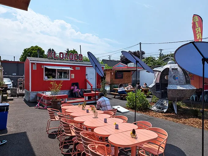 Coral-colored tables create a cheerful oasis where strangers become friends, united by the universal language of exceptional comfort food.