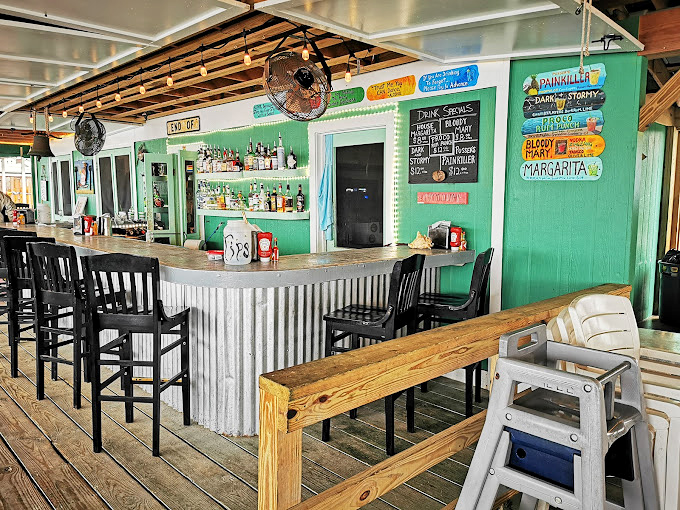 Pull up a seat at the mint-green bar where casual vibes and potent margaritas flow as freely as the coastal breezes.