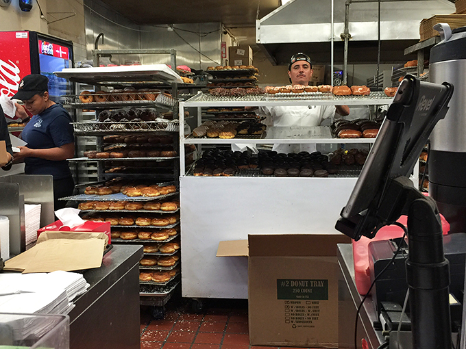 Behind the scenes at donut headquarters, where the magic happens 24/7. Like Willy Wonka's factory, but with more glaze and less singing.
