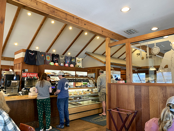 Wooden beams, warm lighting, and the promise of sugar-laden bliss. This isn't just a bakery counter—it's the pearly gates of pastry heaven.