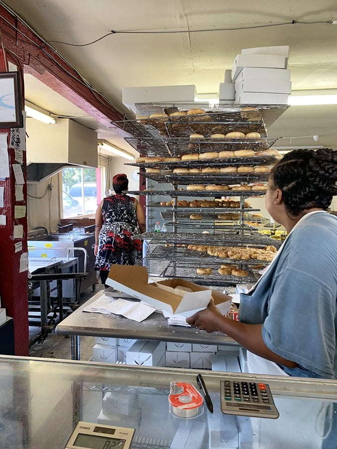Behind the scenes, racks of freshly made donuts cool before their grand debut. This is where the magic happens, folks!