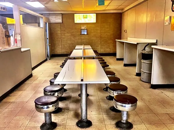 Diner-style seating with fixed stools tells you everything you need to know—this place prioritizes donuts over interior design, exactly as it should.