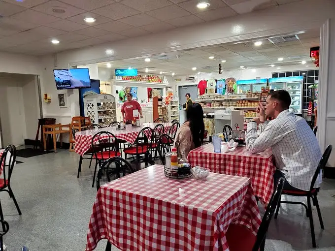 Classic red-checkered tablecloths set the stage for culinary memories. This isn't interior design—it's a promise that authentic, unfussy goodness awaits.