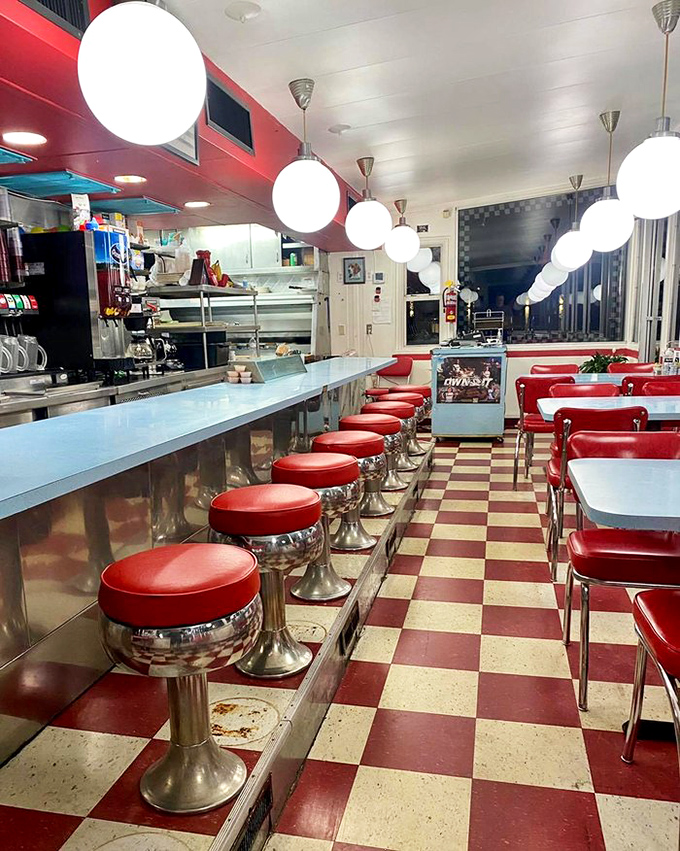 Classic Americana in all its glory—red vinyl stools, checkered floors, and globe lights create the perfect backdrop for morning rituals and comfort food celebrations.