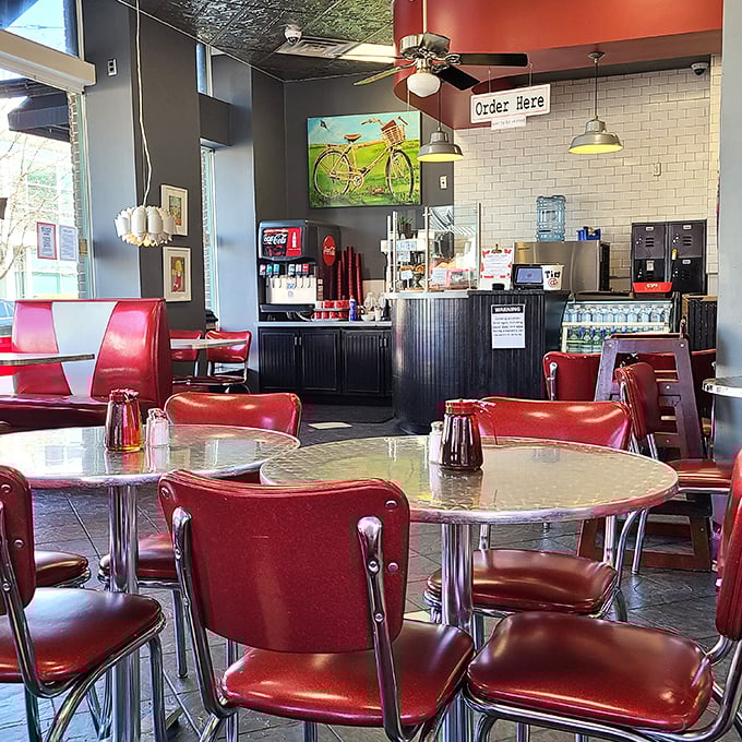 Classic diner vibes with a modern twist—those cherry-red chairs aren't just sitting pretty, they're front-row seats to some of Little Rock's most satisfying comfort food.