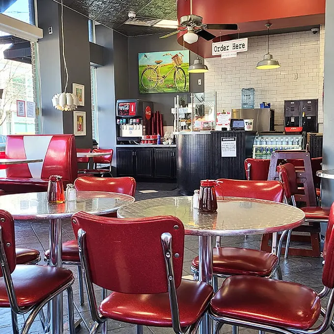 Classic diner vibes with a modern twist—those cherry-red chairs aren't just sitting pretty, they're front-row seats to some of Little Rock's most satisfying comfort food.