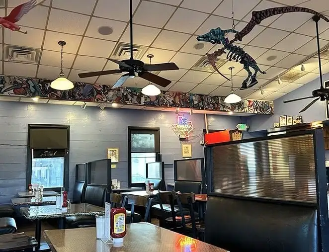 Dinosaur skeletons dance across the ceiling while vintage Texas memorabilia lines the walls – Austin's quirky soul captured perfectly in one cozy room.
