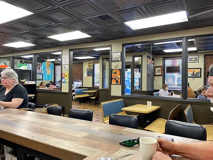 Inside, classic diner vibes meet South Carolina soul. The tin ceiling and wooden tables whisper, "Stay awhile, the coffee's always full."