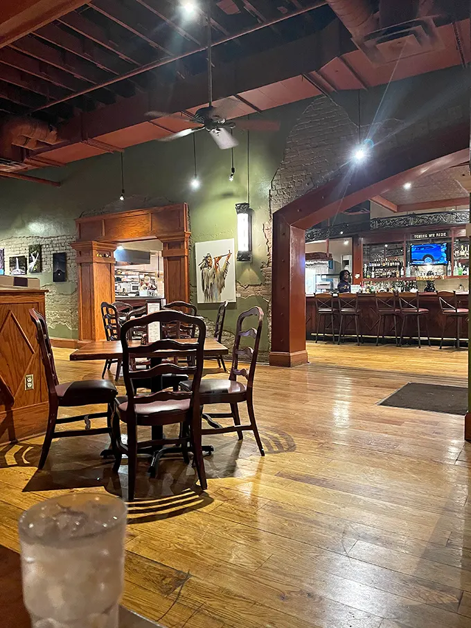 Step inside and the magic begins—exposed brick, warm wood tones, and that perfect lighting that says "stay awhile." The bar beckons from just beyond.