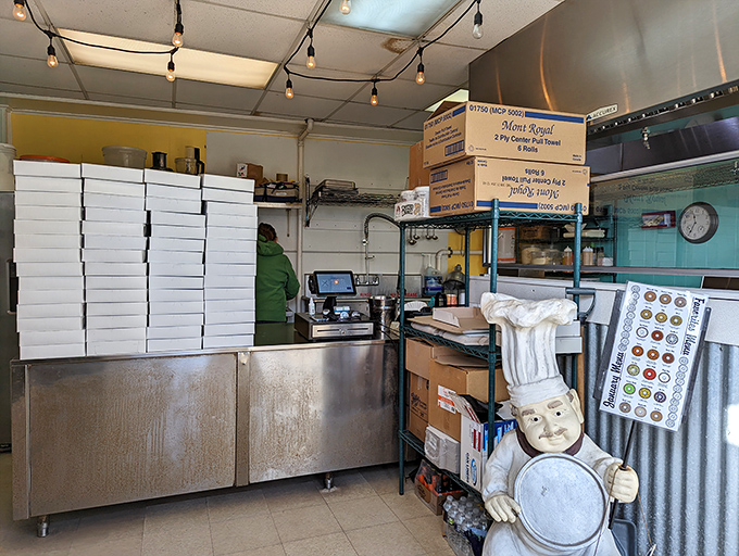 Inside this modest space, donut magic happens daily. Those white boxes stand ready for the parade of circular joy that keeps locals coming back.