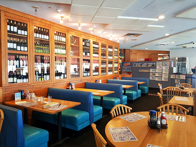 Blue booths and wooden tables create that perfect casual-but-serious seafood atmosphere. The wine display suggests they understand what pairs with ocean treasures.