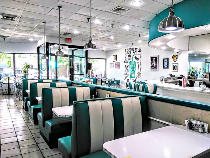 Sliding into these teal and cream booths feels like slipping into a Cadillac with fins. The classic diner interior balances nostalgia with comfort in every chrome detail.