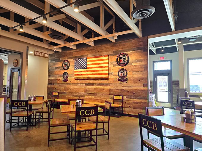 Rustic meets refined in this dining space where competition badges tell tales of barbecue glory and that wooden American flag stands proudly over meat masterpieces.