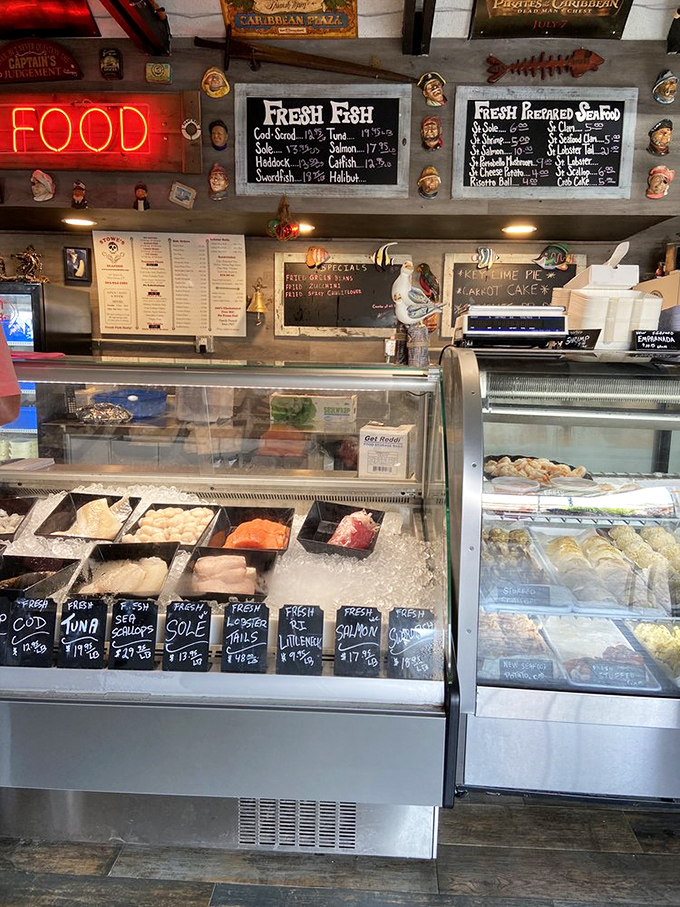 The neon "FOOD" sign isn't lying—this seafood counter is where dreams of fresh fish come true, with sailor figurines standing watch over the day's catch.