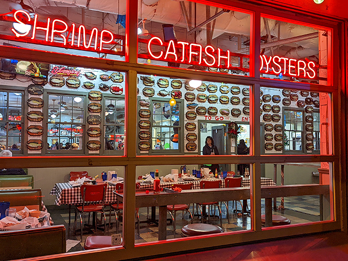 The neon glow of Flying Fish's window signs promises three essential food groups: shrimp, catfish, and oysters – the holy trinity of Memphis seafood salvation.