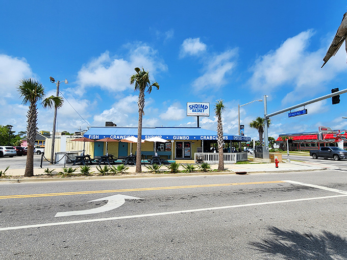The Shrimp Basket's cheerful blue and yellow exterior is like a Jimmy Buffett song come to life—casual, coastal, and promising a good time.