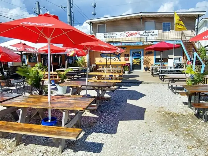 Red umbrellas shield happy diners from the sun while they crack into crawfish seasoned to Cajun perfection.