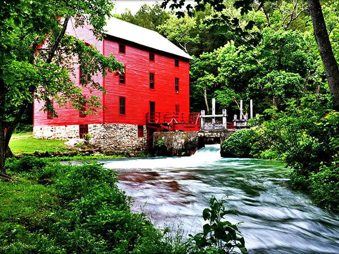 Alley Spring Mill's iconic red exterior stands out against emerald waters like nature's exclamation point, drawing photographers and daydreamers alike.
