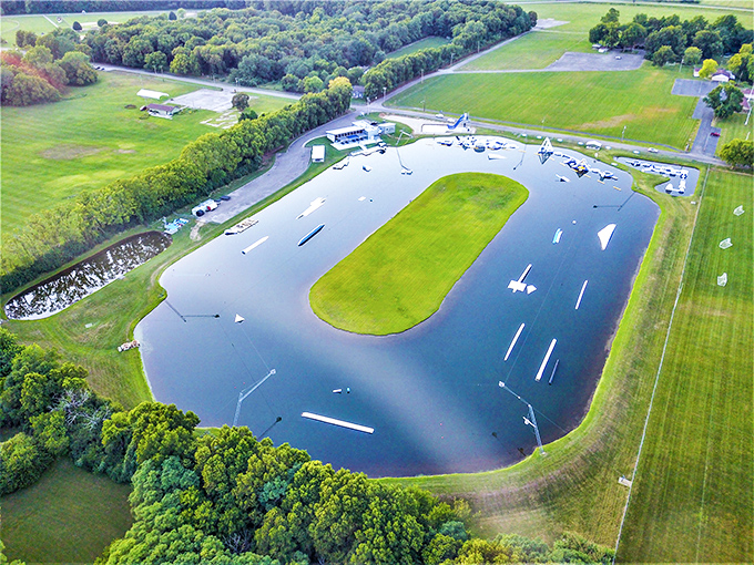 The aerial view showcases Wake Nation's ingenious design—a human-made lake surrounded by nature, with inflatable challenges awaiting the brave.
