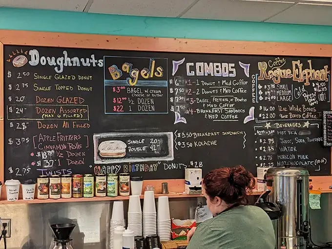 This chalkboard menu isn't just information—it's a roadmap to happiness. Each colorful entry represents a different path to donut nirvana.