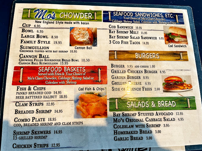 Mo's menu reads like coastal poetry—chowder in bread bowls, seafood baskets, and the legendary Slumgullion that locals whisper about reverently.
