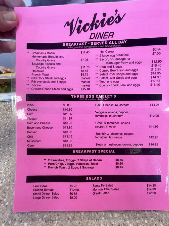 The iconic pink menu at Vickie's—where breakfast is an all-day affair and decisions are harder than picking the right slot machine.