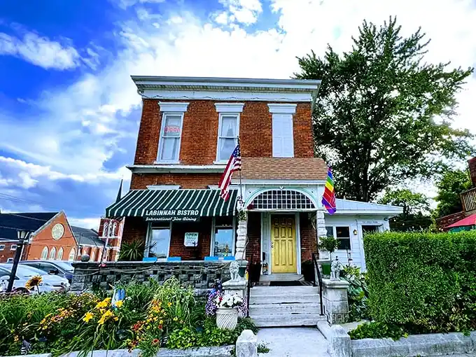 The LaBinnah Bistro welcomes visitors with classic brick architecture and blooming flowers—a charming spot where literary history meets modern cuisine.