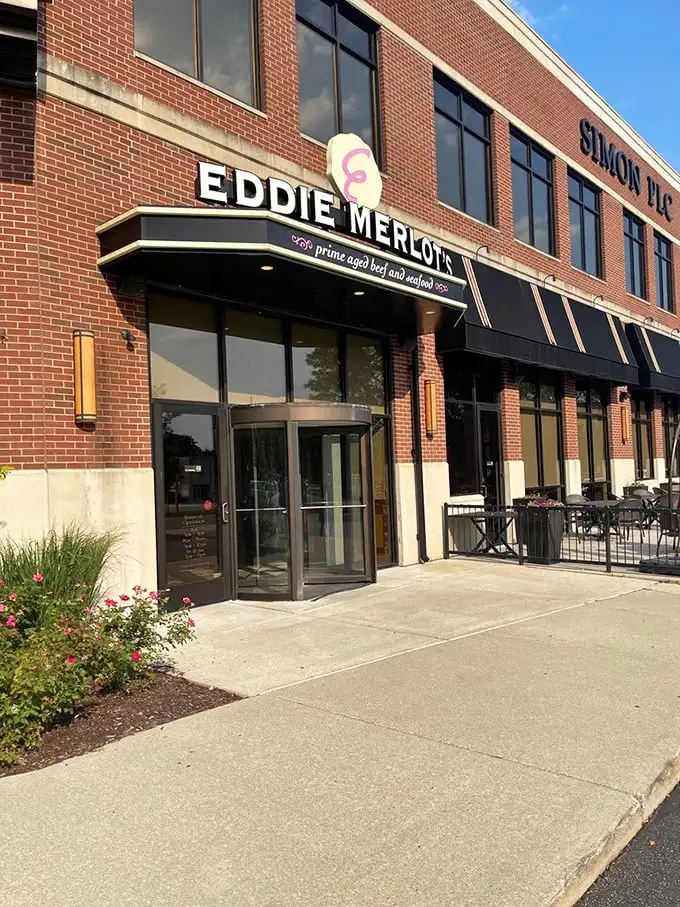 Brick, glass, and a revolving door – Eddie Merlot's understated exterior belies the flavor explosion waiting within.