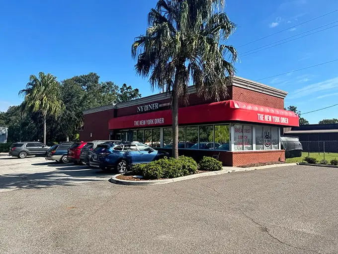 Under that bold red awning lies a world where sandwiches require building permits and the coffee never sleeps.