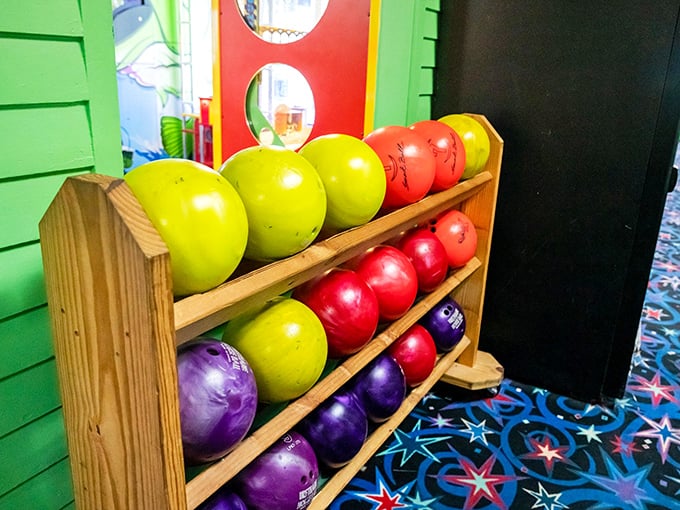 A rainbow of bowling balls awaits your selection – will you choose based on weight, finger fit, or simply because that purple one matches your shoes?